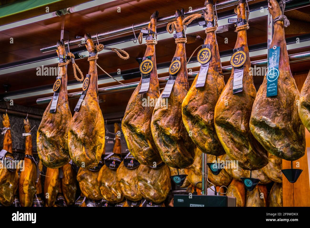 VALENCIA, SPAIN, DECEMBER 30, 2015: Hanging Jamon meat in shop. Spanish ...