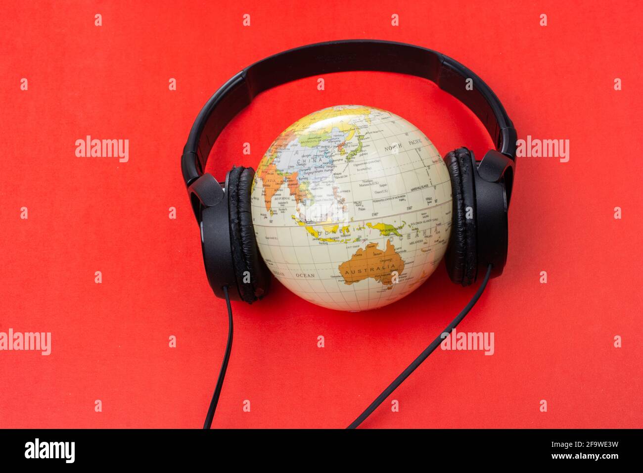 Headset on globe isolated on the red Stock Photo - Alamy