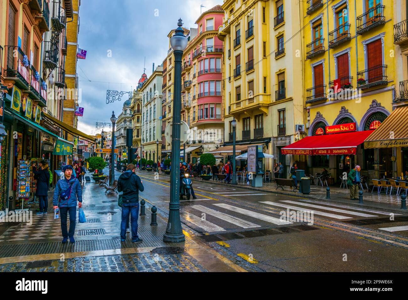 GRANADA, SPAIN, JANUARY 3, 2016: people are strolling through center of ...