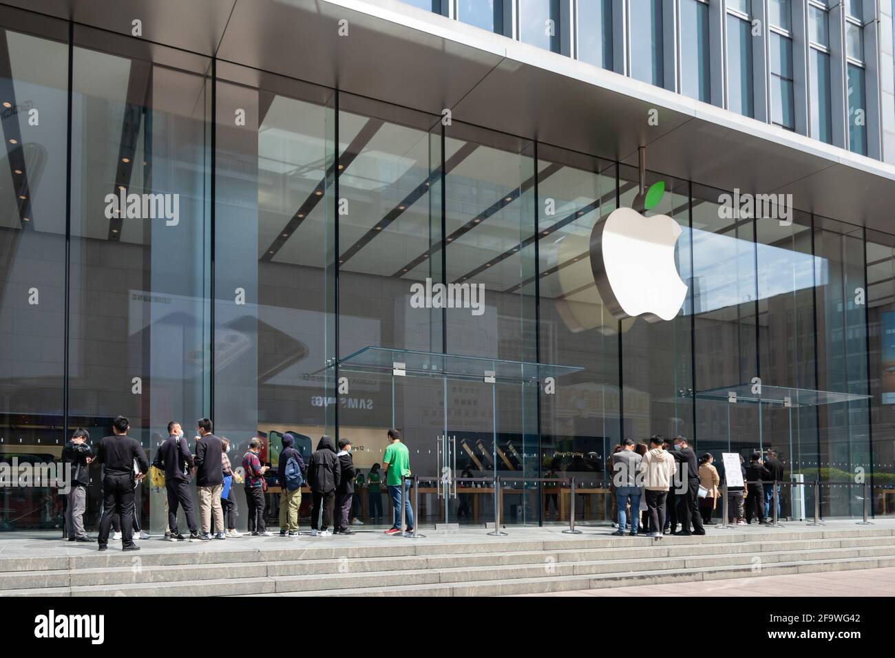 SHANGHAI, CHINA - APRIL 20, 2021 - Customers queue to enter an Apple ...