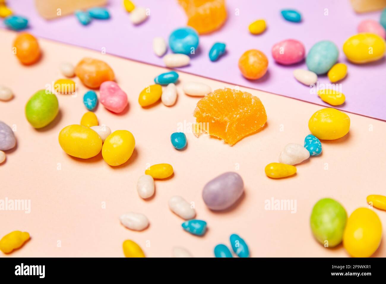 Bunch of multicolored dragee candies of different sizes and fruit jelly ...