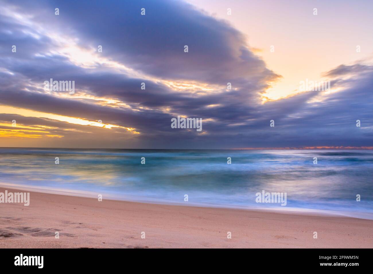 Overcast cloudy sunrise over a rough Indian Ocean from a view point on ...