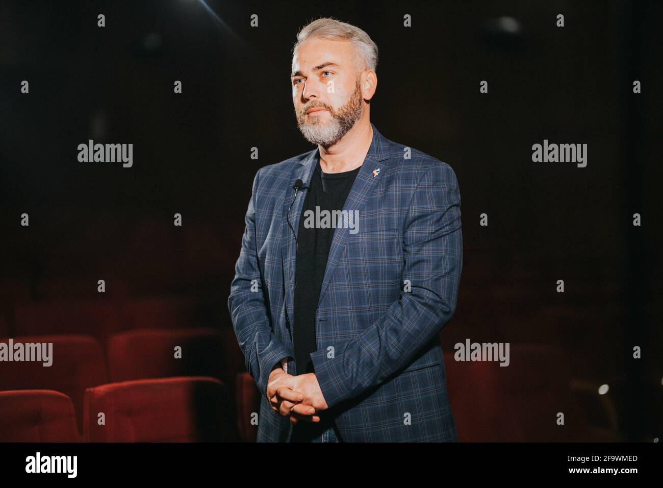 Elegant male theatre and movie director giving an interview in ...