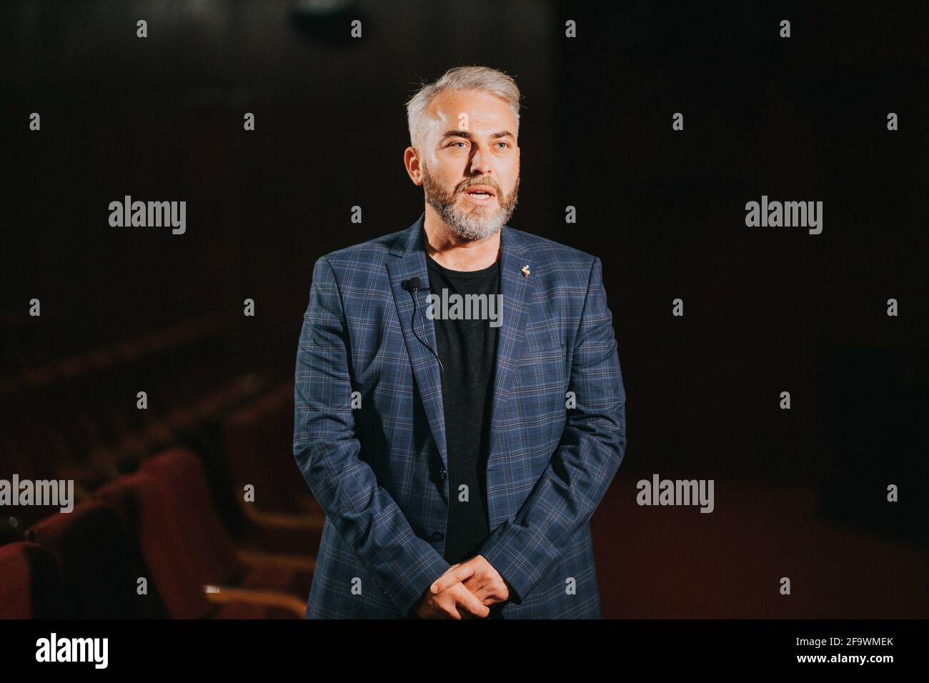 Elegant male theatre and movie director giving an interview in ...