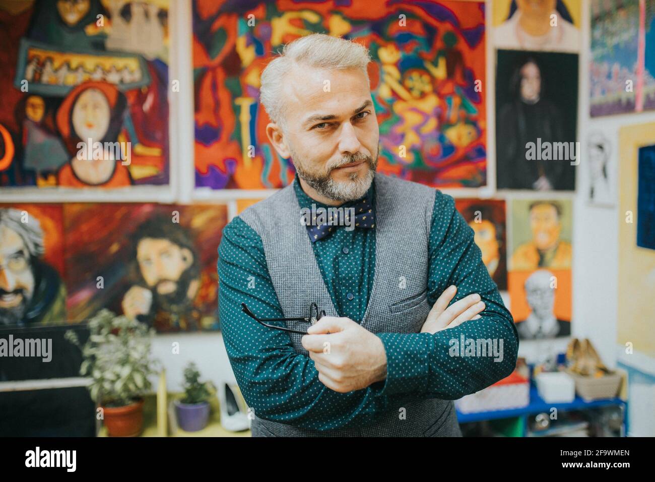 Elegant male art gallery director posing in background of the ...