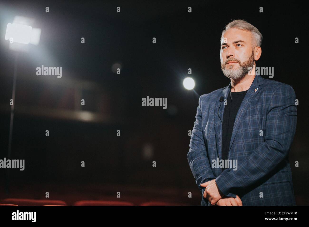 Elegant male theatre and movie director giving an interview in ...