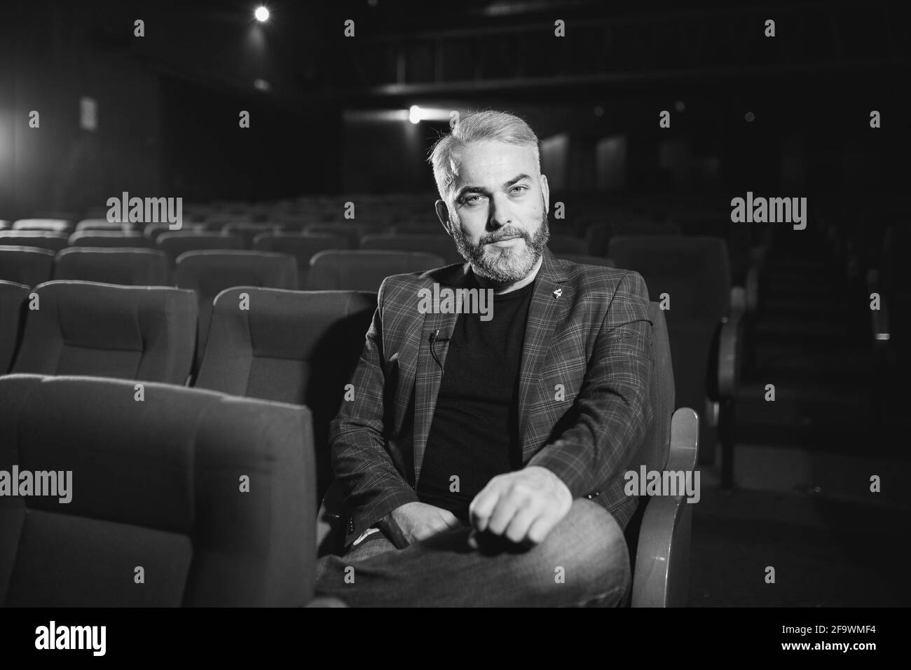 Elegant male theatre and movie director giving an interview in ...