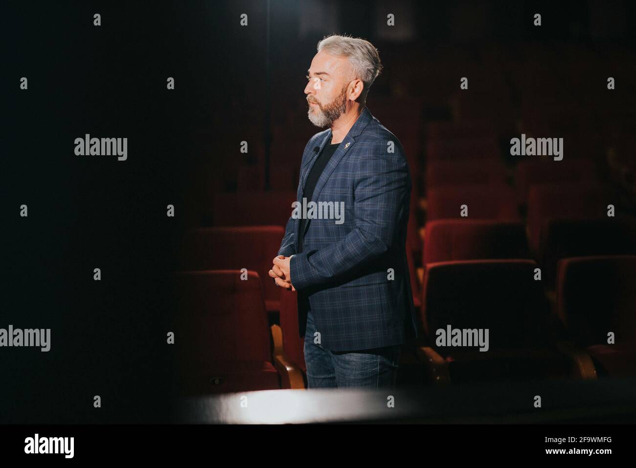 Elegant male theatre and movie director giving an interview in ...