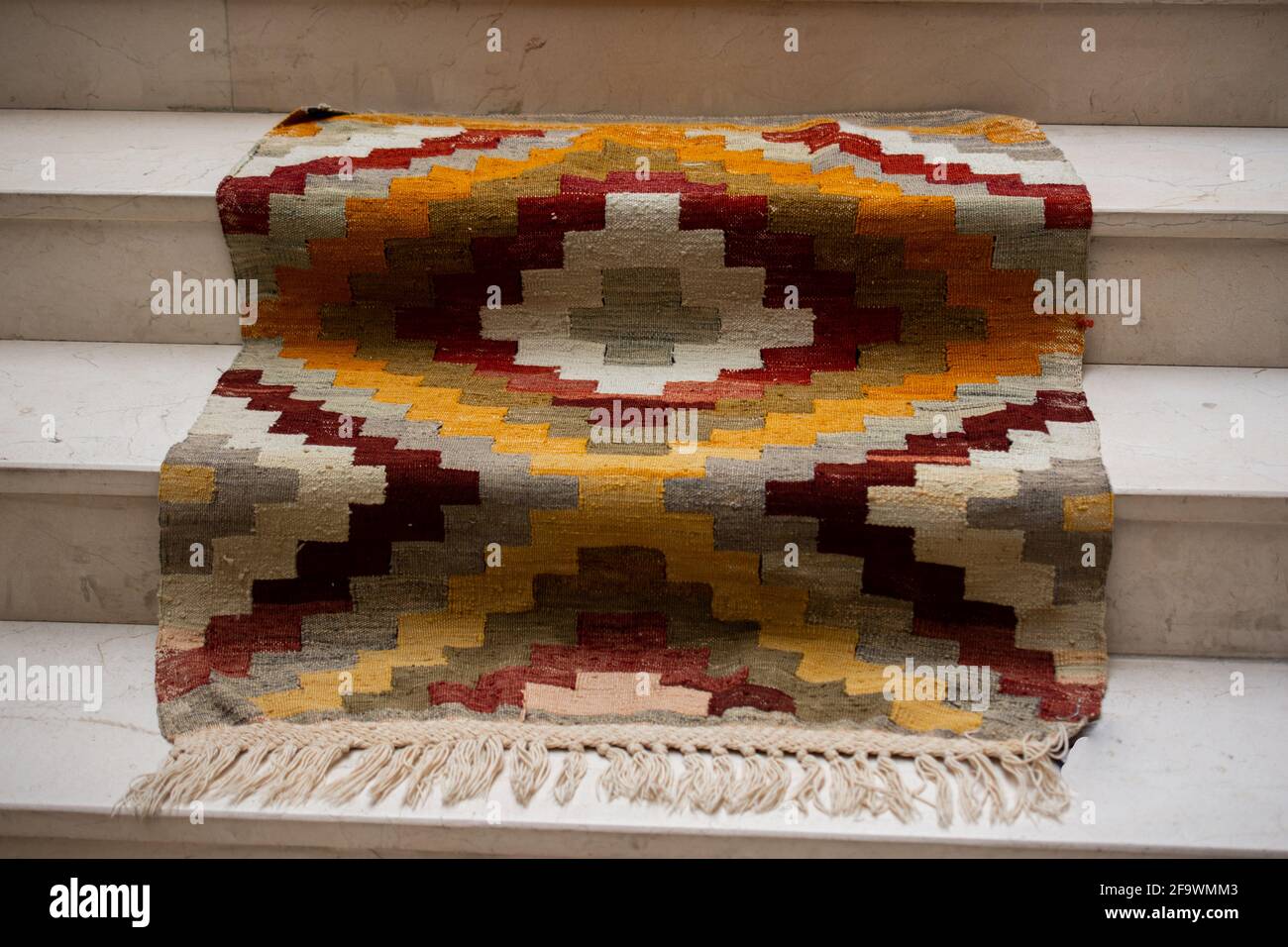 Traditional Turkish rug textile with patterns in bazaar Stock Photo - Alamy