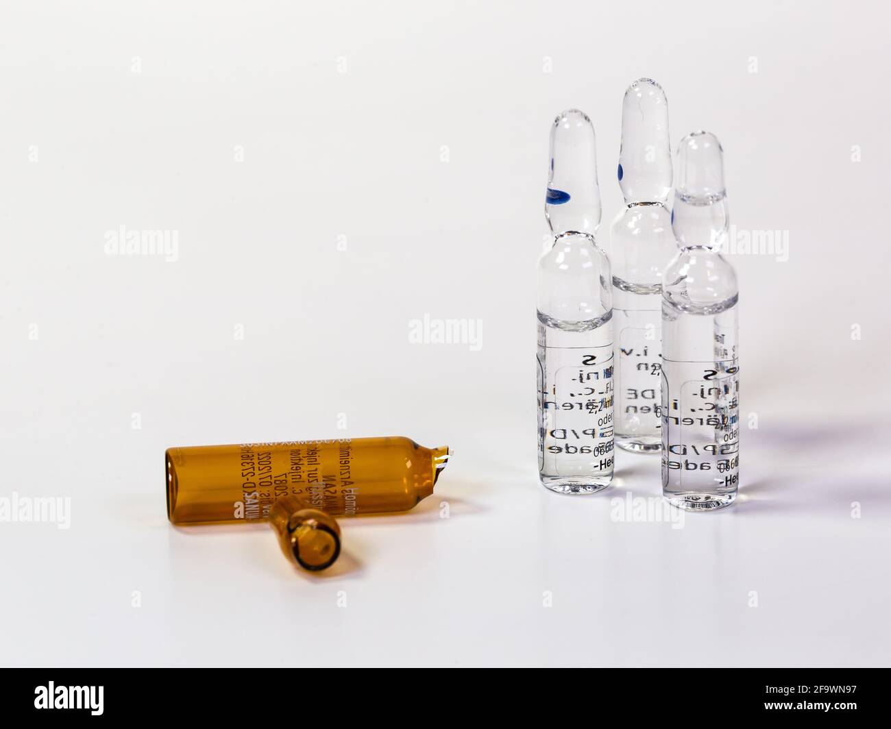 one broken and three unbroken ampules on white background Stock Photo ...