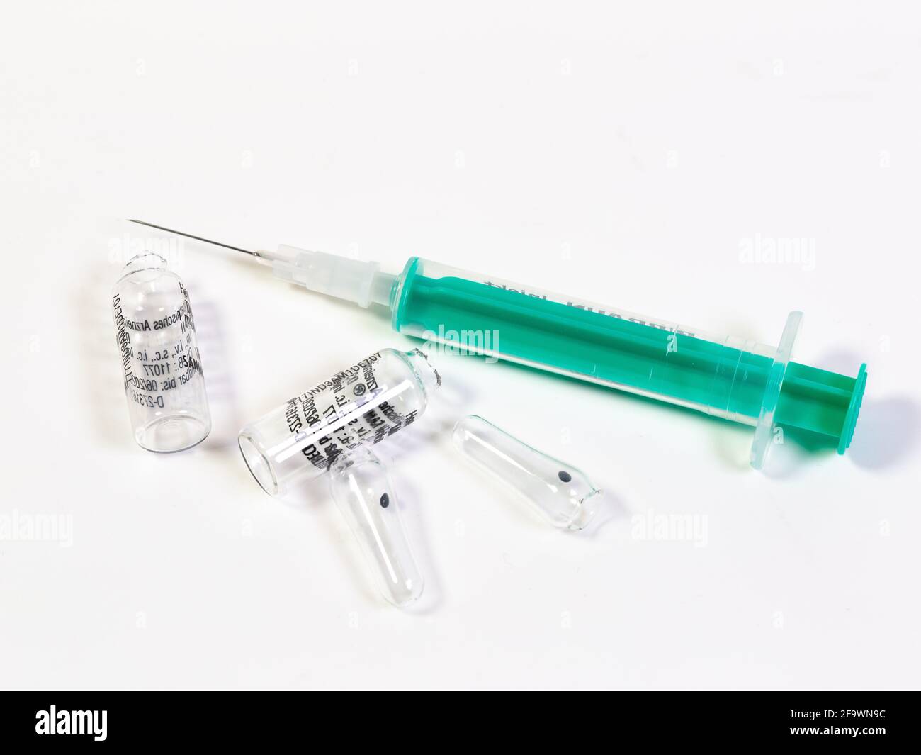a syringe and two broken ampules on white background Stock Photo - Alamy