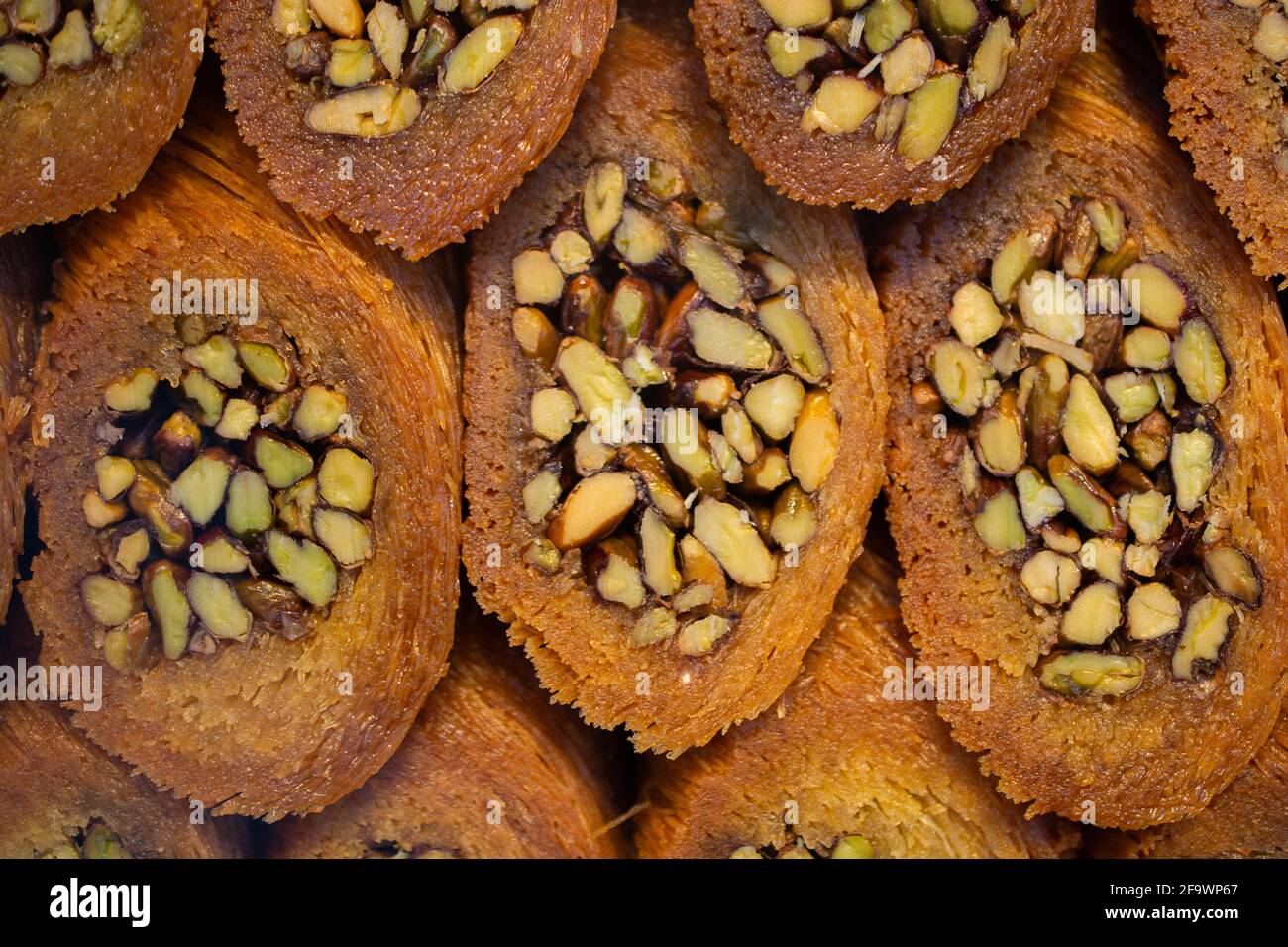 Turkish traditional dessert Kadayif baked in syrup served with nut ...