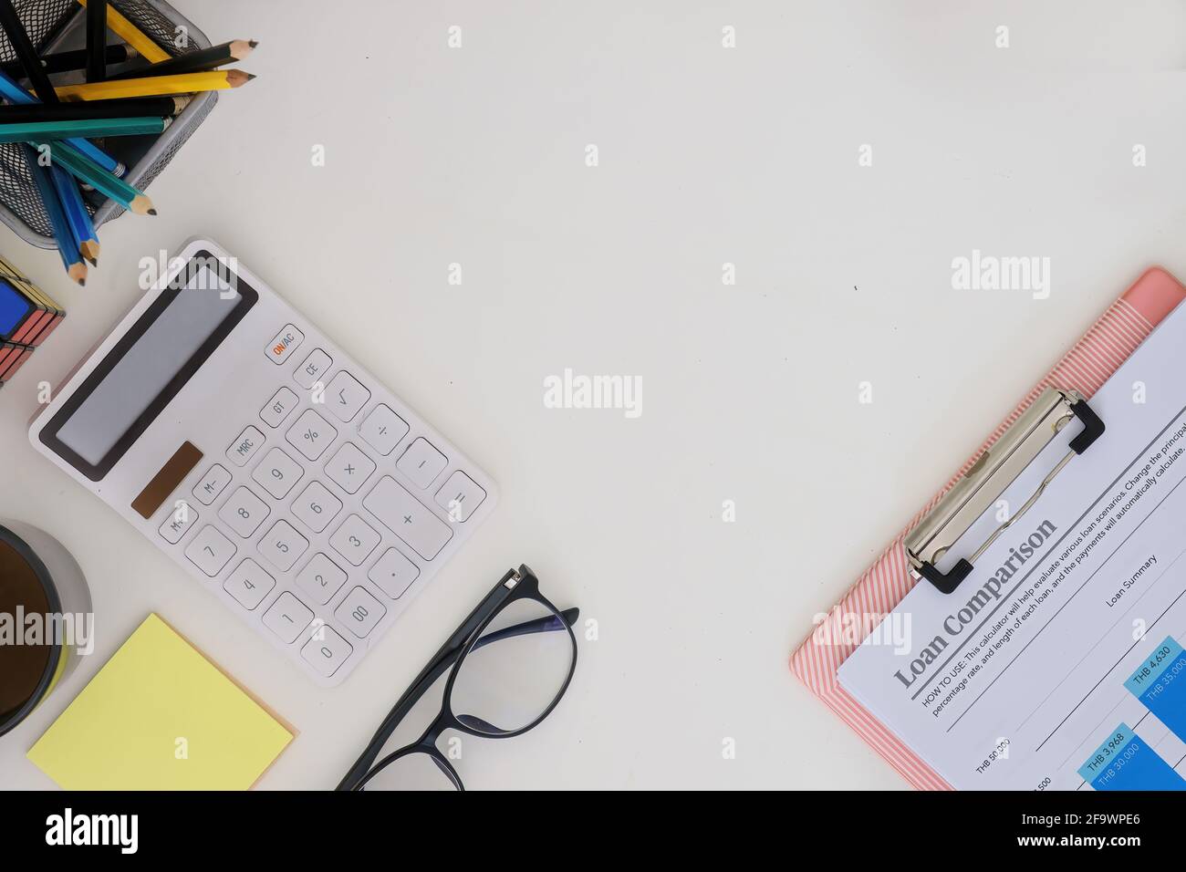 Calculator and paperwork on modern white wooden desk in accountant ...