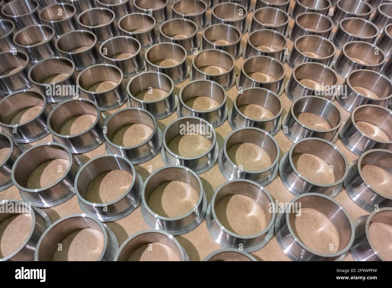 full frame batch array of shiny steel cylindrical sleeve parts with ...