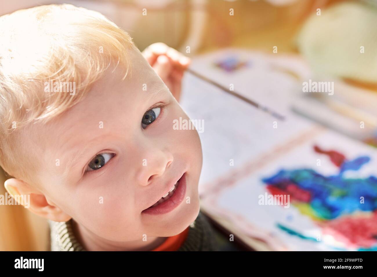 A three-year-old boy paints with gouache coloring, leisure and child ...