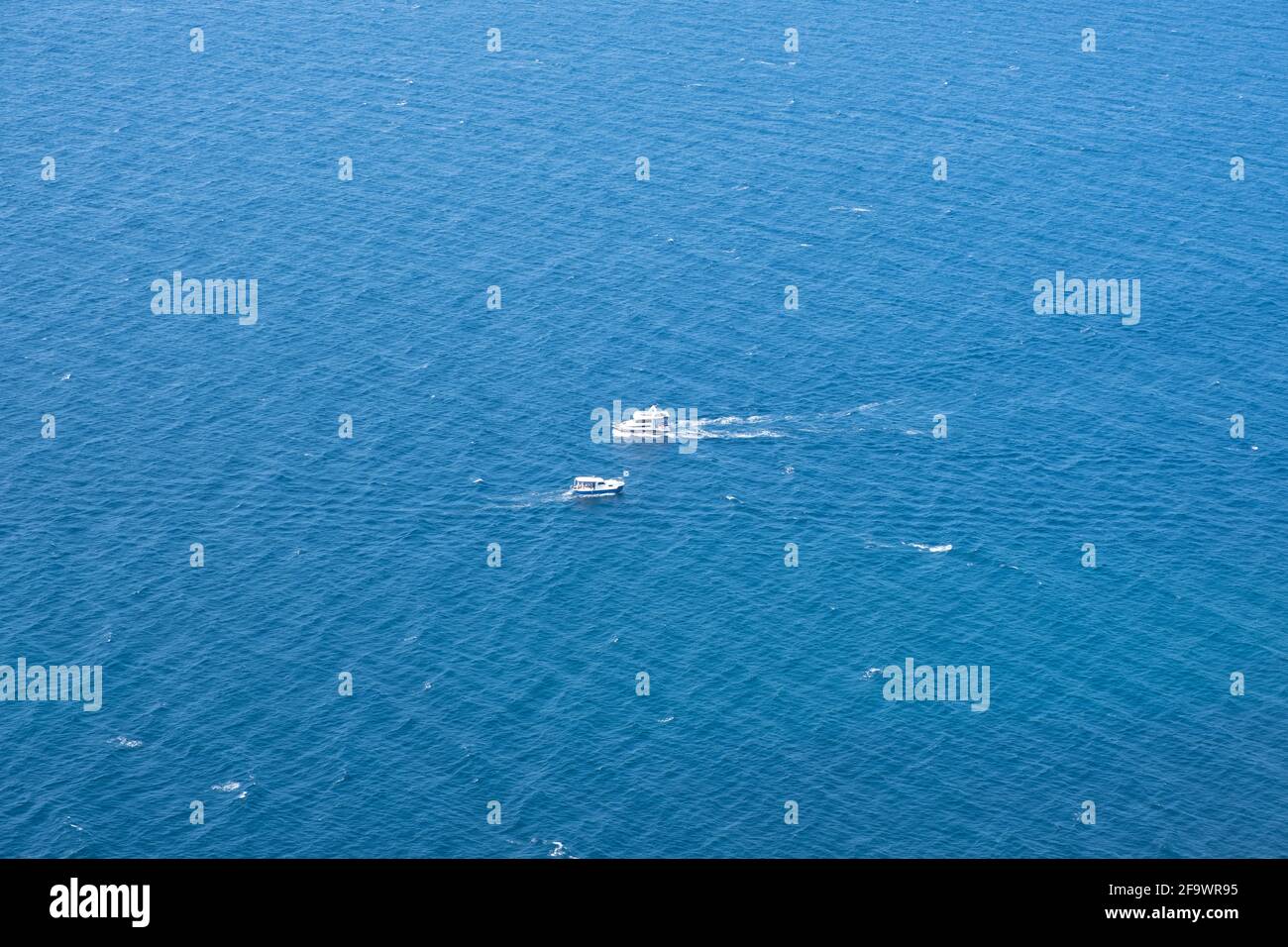 small boat moves on a beautiful blue sea Stock Photo - Alamy