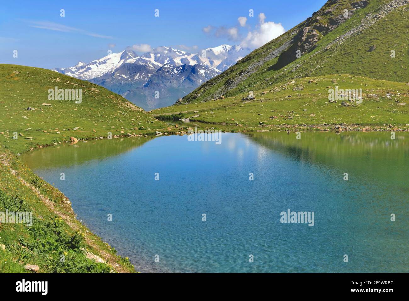 beautiful lake in alpine mountain lake with snowy peak mountain ...