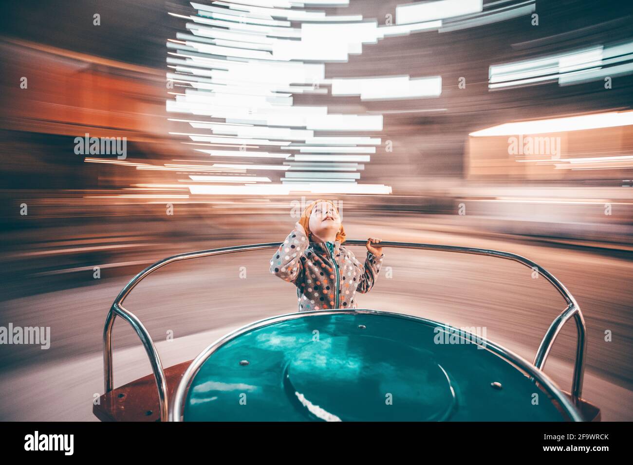 Happy girl having fun on the roundabout on the playground Stock Photo ...