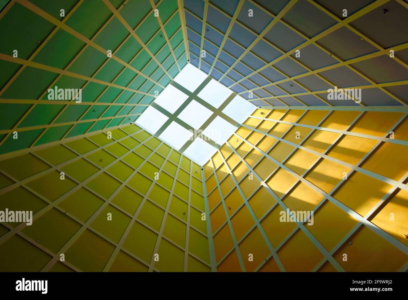 Vertical view of skylight in tower with strong geometric patterns as ...