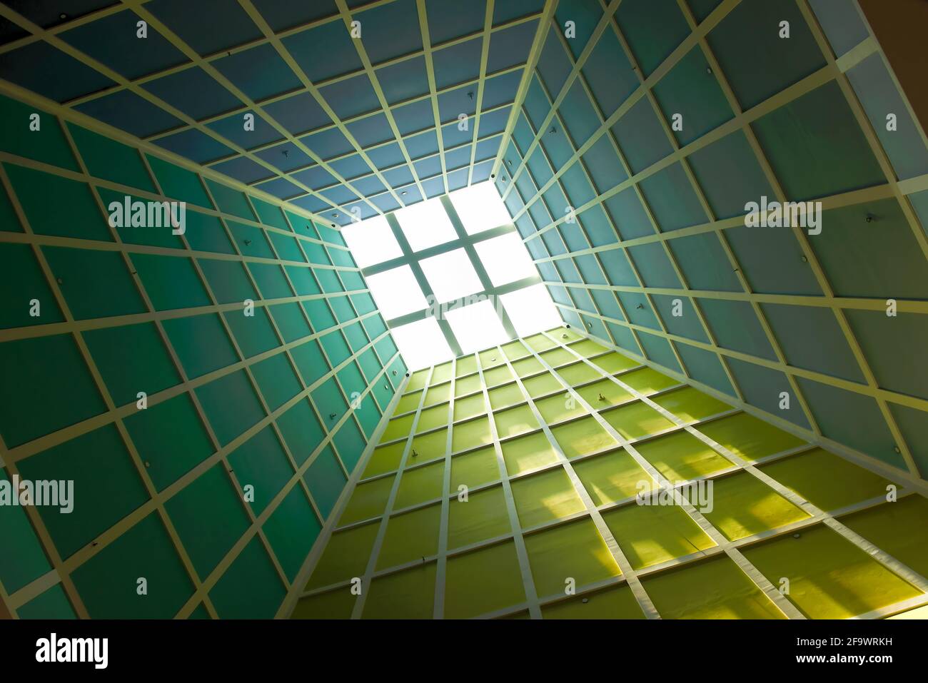 Vertical view of skylight in tower with strong geometric patterns as ...