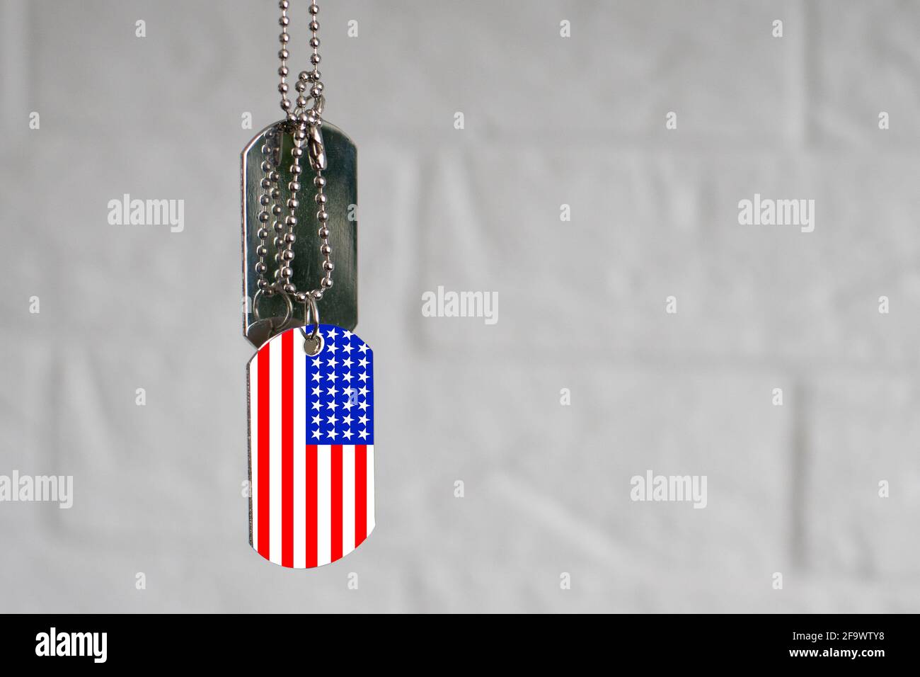Army tokens on American national flag background Stock Photo - Alamy