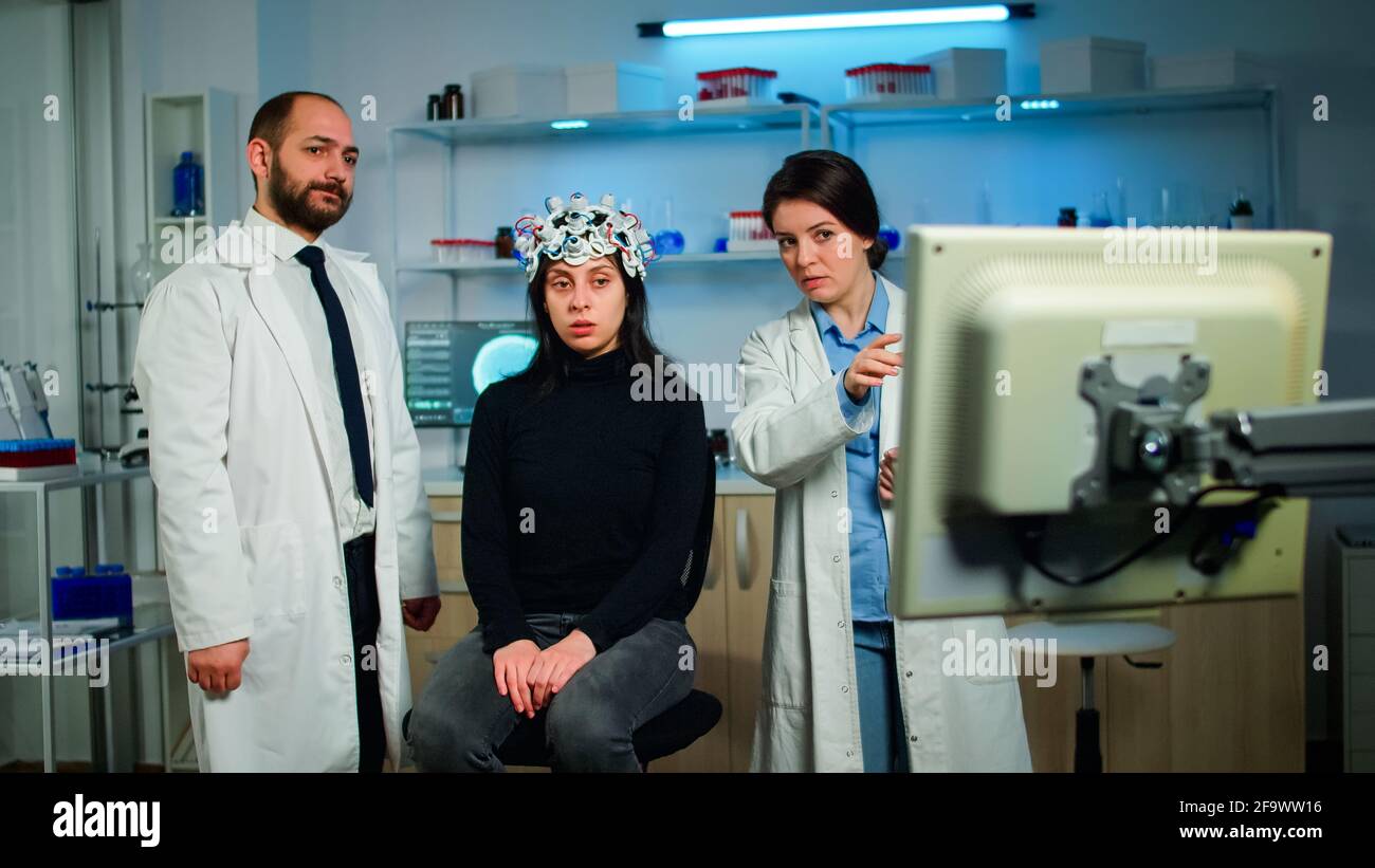 Team of medical researchers testing nervous system of woman patient ...