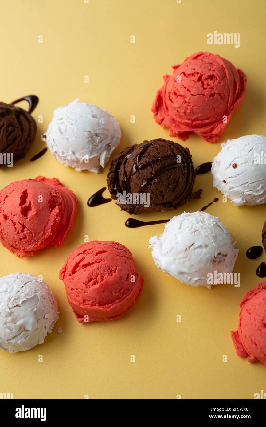 Various ice cream scoops close up on golden surface Stock Photo - Alamy