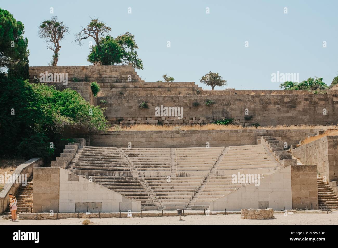 Ancient Stadium of Rhodes in Rhodes, Greece with dark green trees and a ...