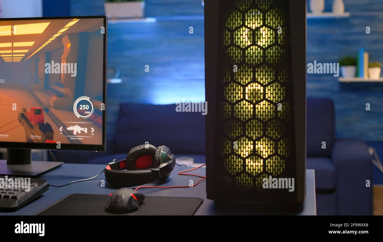 Close-up of RGB system desktop, pro gamer playing first person shooter ...