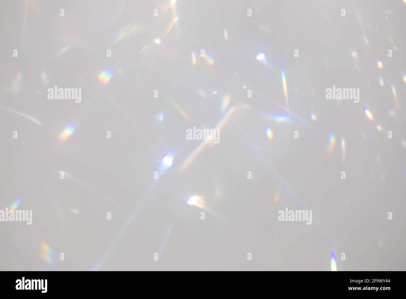 Blurred rainbow light refraction texture on white wall Stock Photo - Alamy
