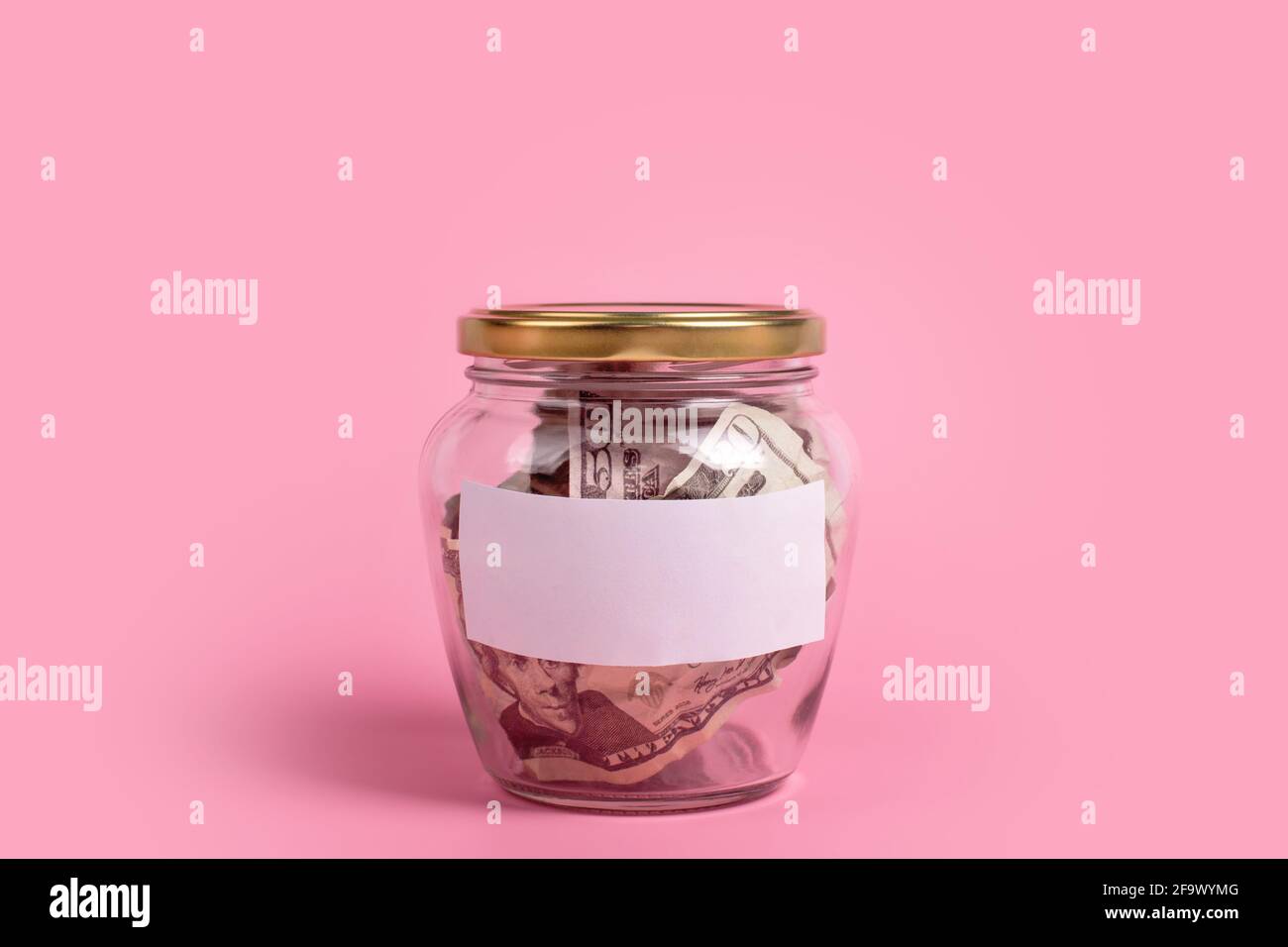 American dollars in glass money jar with blank label, financial, saving ...