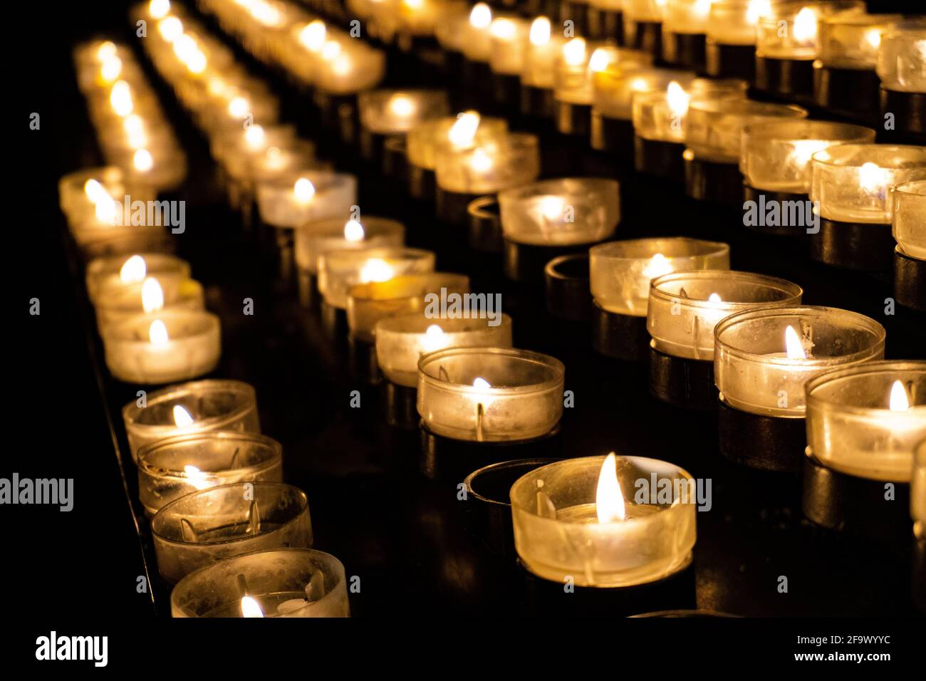 Selective focus shot of many burning candles in a row Stock Photo - Alamy