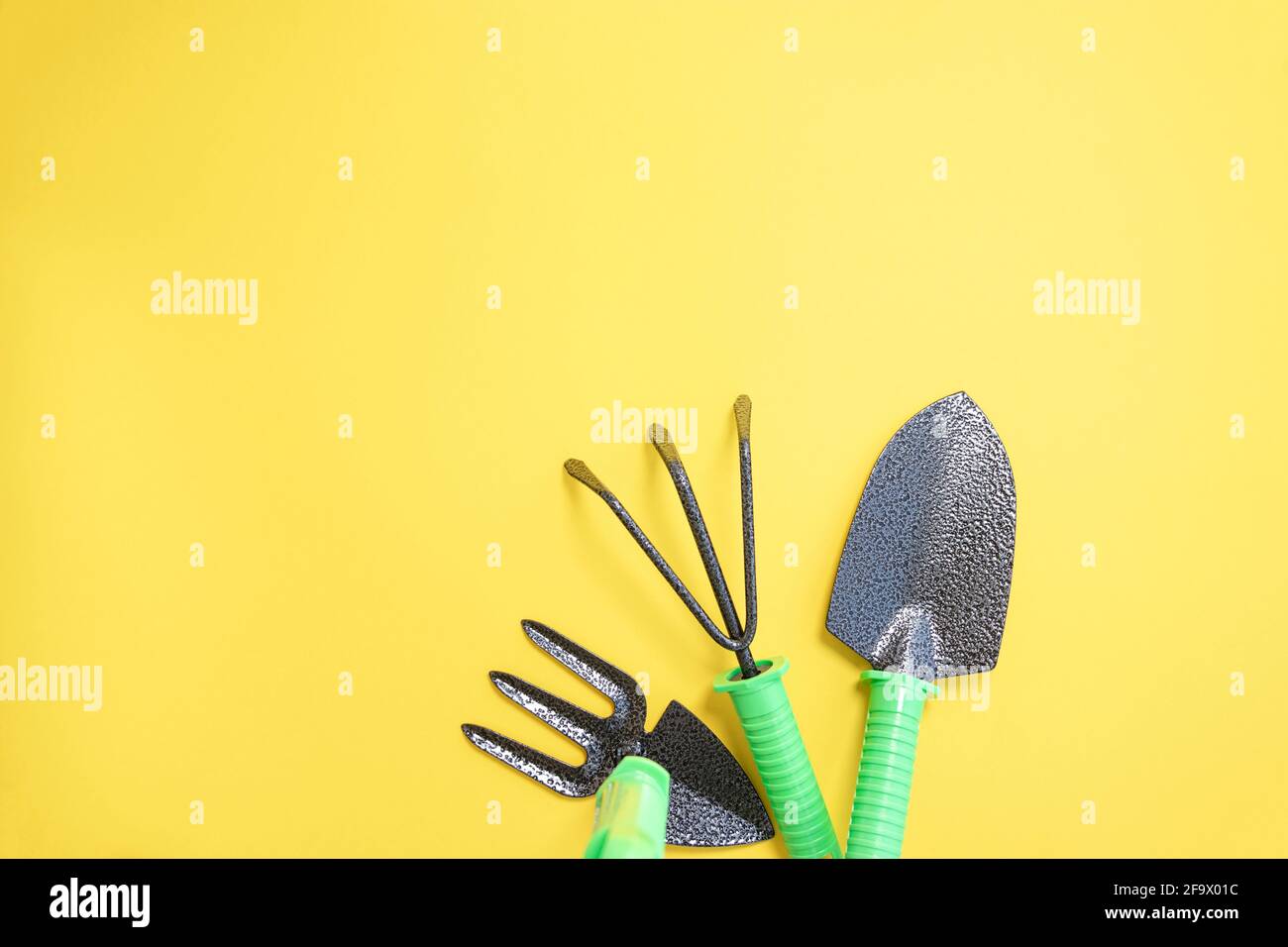Gardening tools rake, shovel on a yellow background. backyard vegetable ...