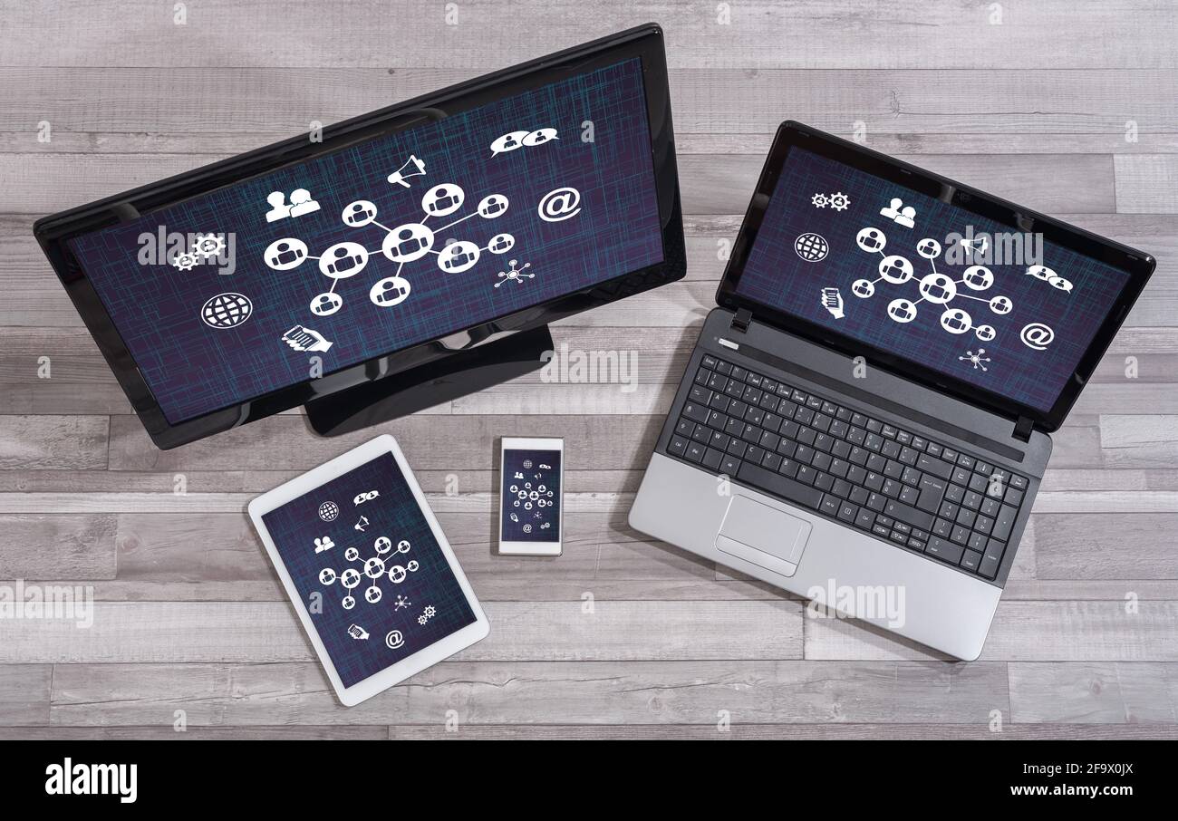 Social network concept shown on different information technology ...