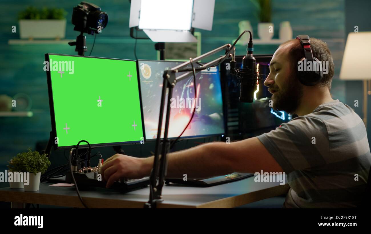 Professional cyber streamer playing online videogames on professional ...