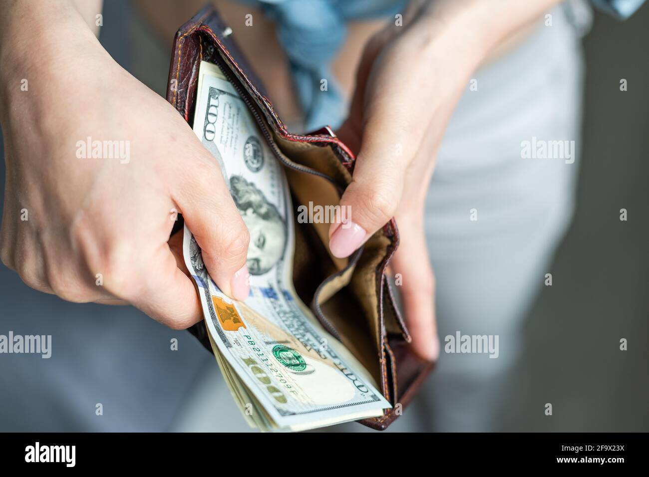 Rich woman taking from purse money Stock Photo - Alamy