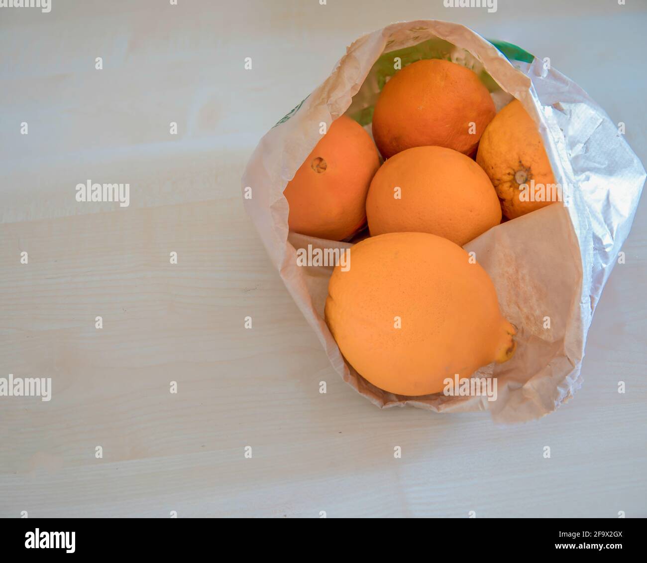 Oranges In Paper Bag. Copy Space.Five fresh oranges inside a grocery ...