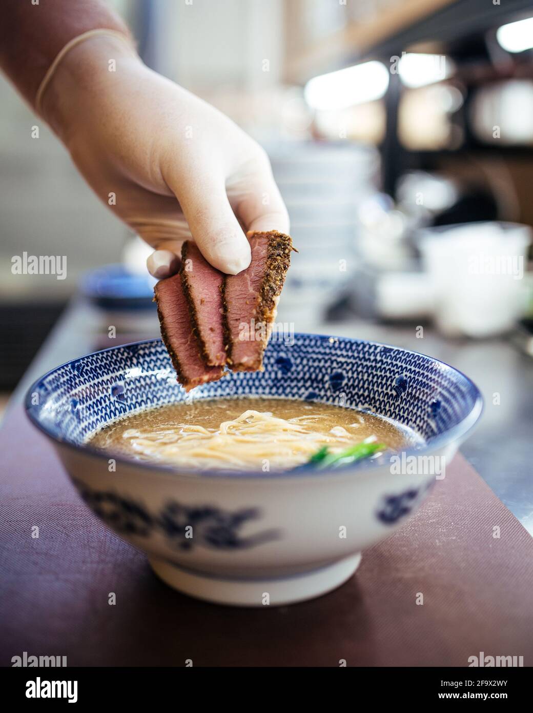 Cooking japanese ramen noodle soup with pastrami Stock Photo - Alamy