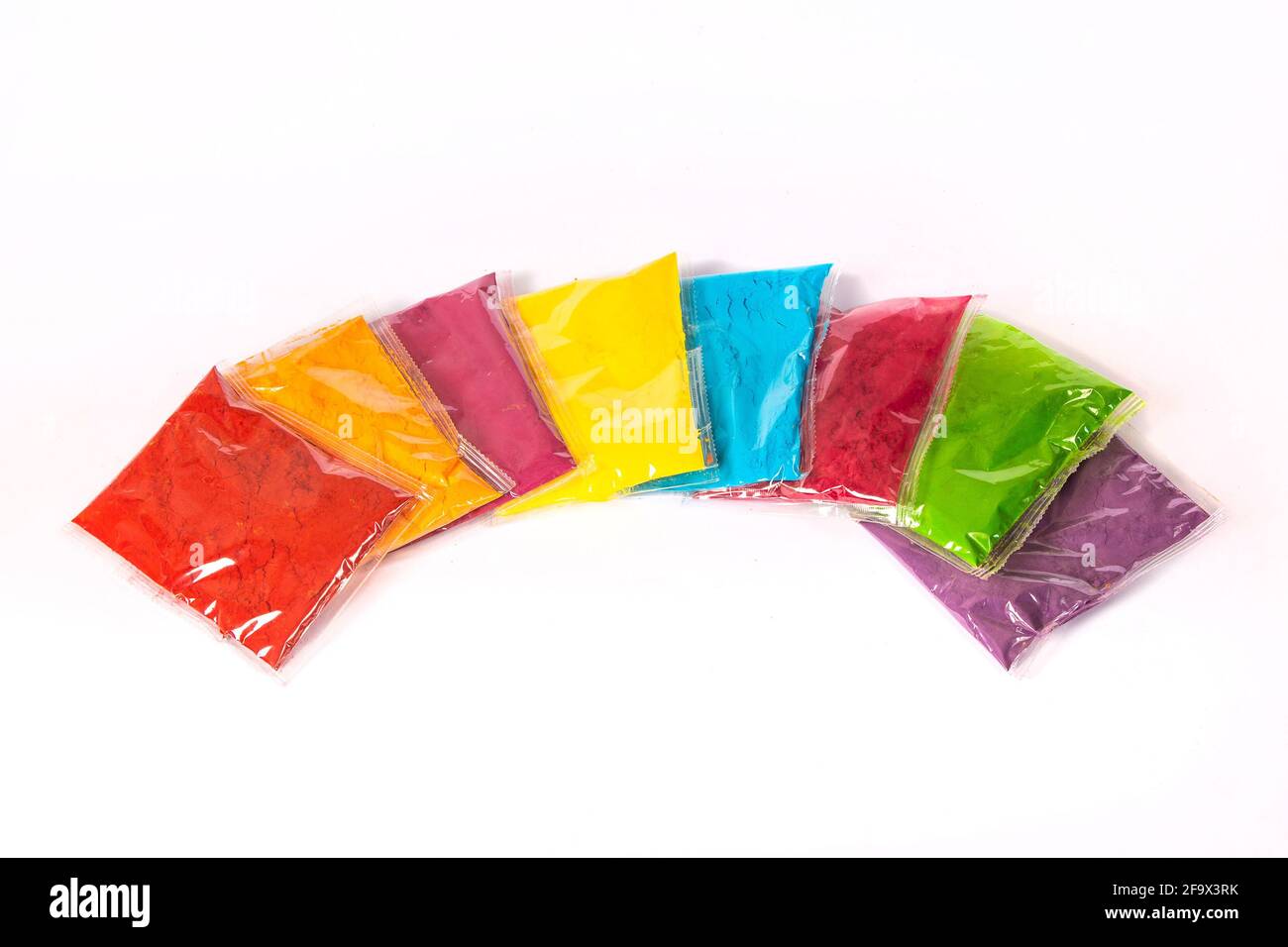 Colorful powders in a plastic packet isolated on a white background ...