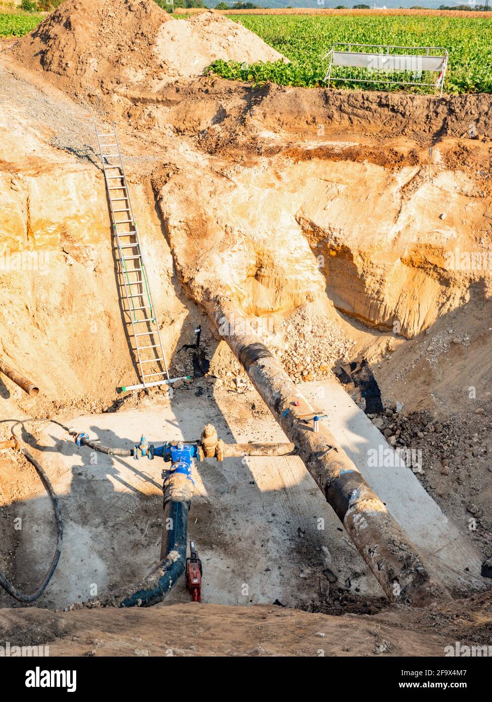 Deep trench in ground to for a large water supply pipeline. Reapiring ...