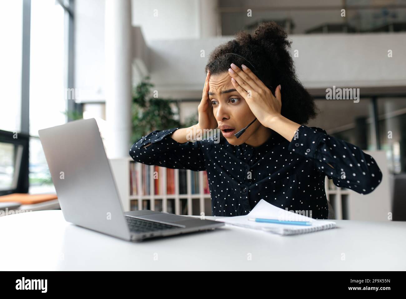 Irritated shocked young African American woman, employee, manager or ...