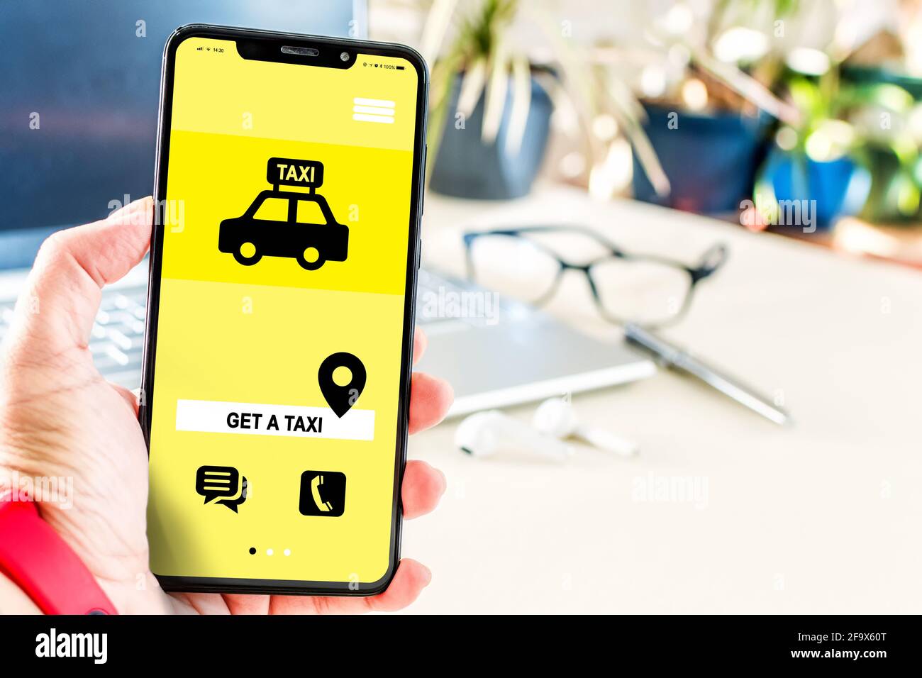 Selective focus of a hand holding a smartphone showing an uber app at a ...