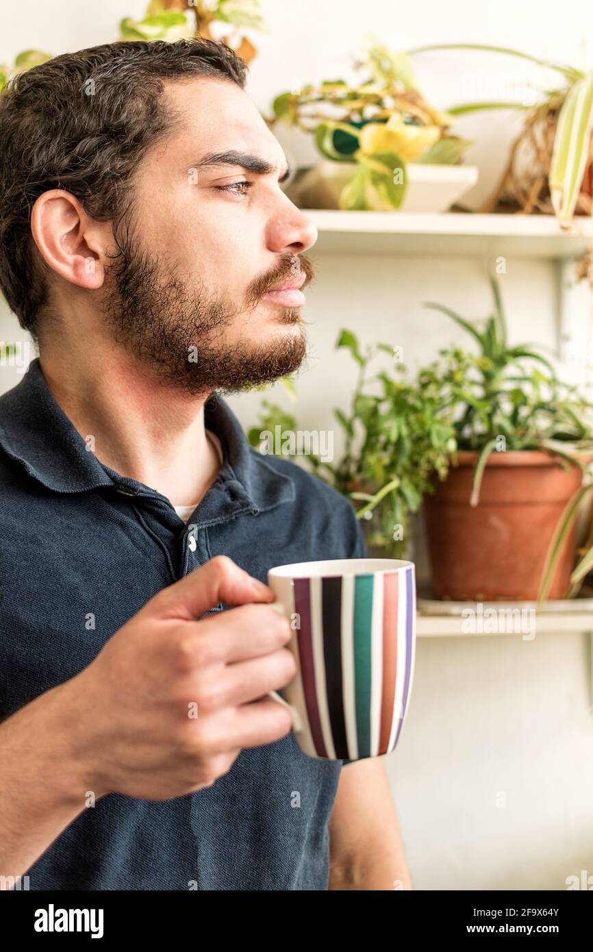 Vertical shot of a young Jewish man drinking coffee in the morning ...