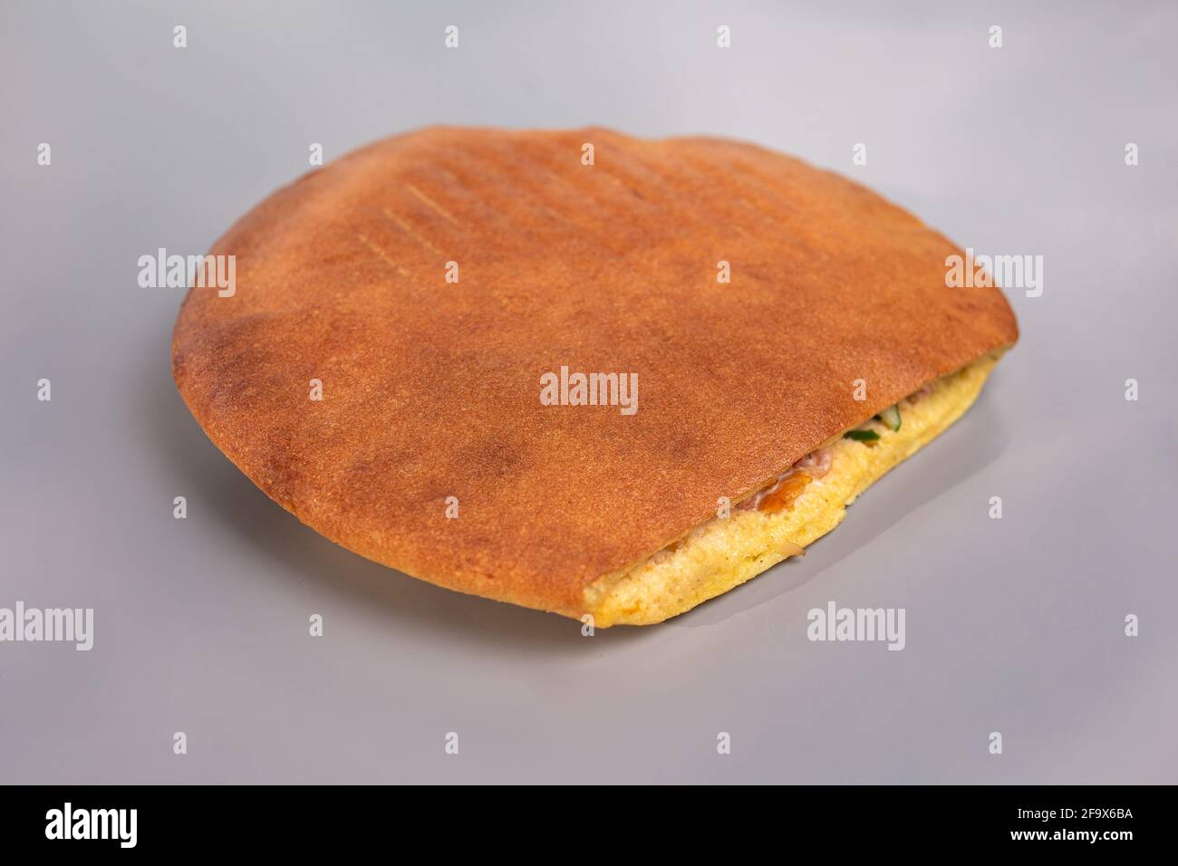 doner in a round flatbread on a gray background Stock Photo - Alamy