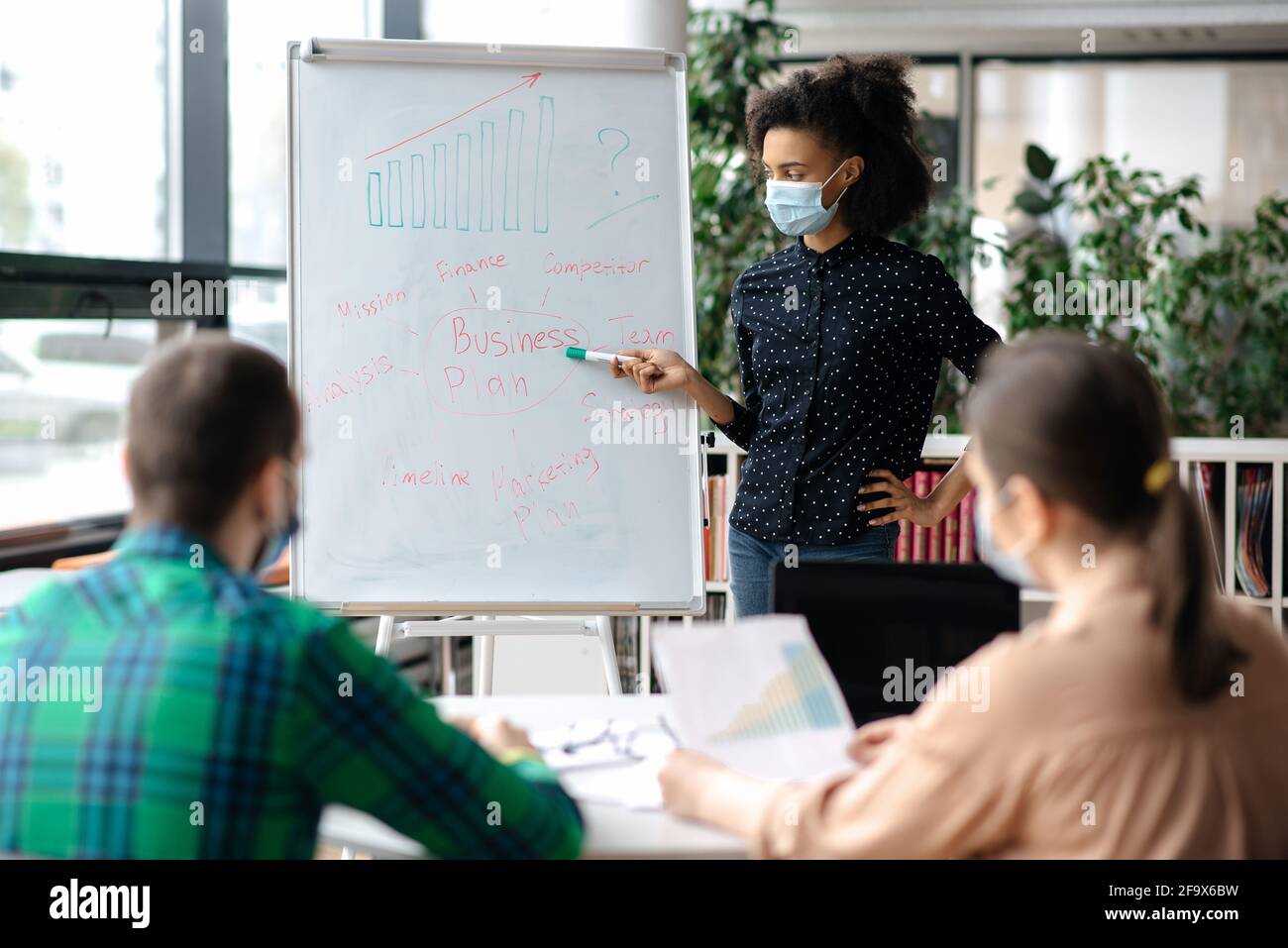 Colleagues working whiteboard office hi-res stock photography and ...