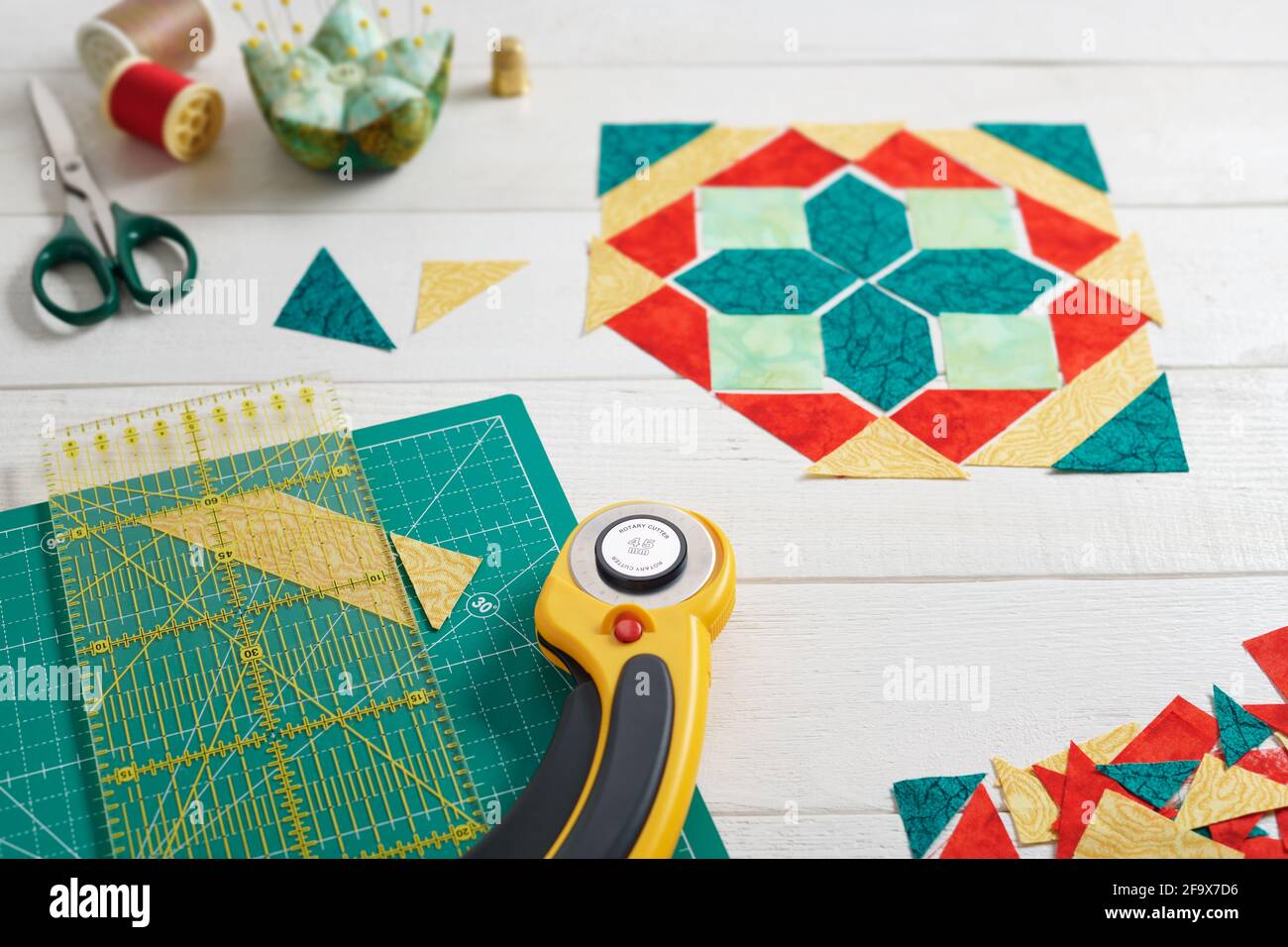 Pieces of fabric laying out in the shape of a patchwork block, sewing ...