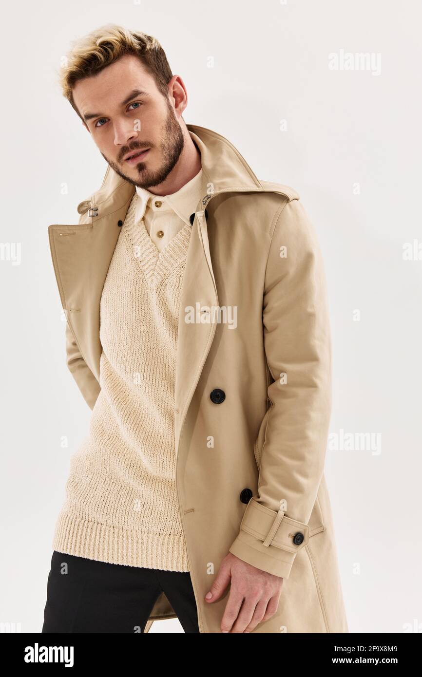 handsome man in coat studio fashion attractive look light background ...