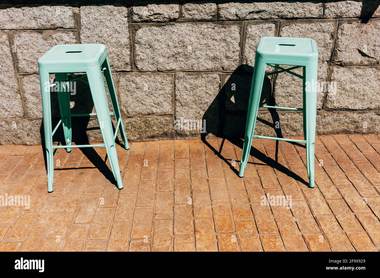 Closeup of two free plastic stools at the outdoor bar Stock Photo - Alamy