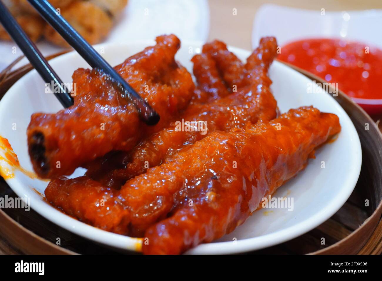 Plate of braised chicken feet with tomato sauce Stock Photo - Alamy