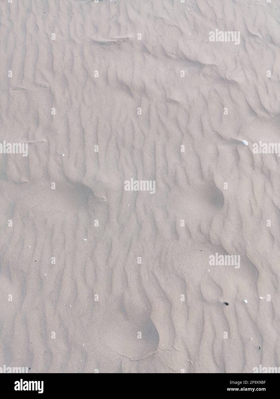 Top view of sand texture with slightly visible footprints on the ...